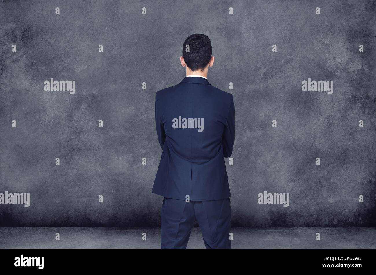 Facing the future with decisiveness. A rear view of a businessman ...
