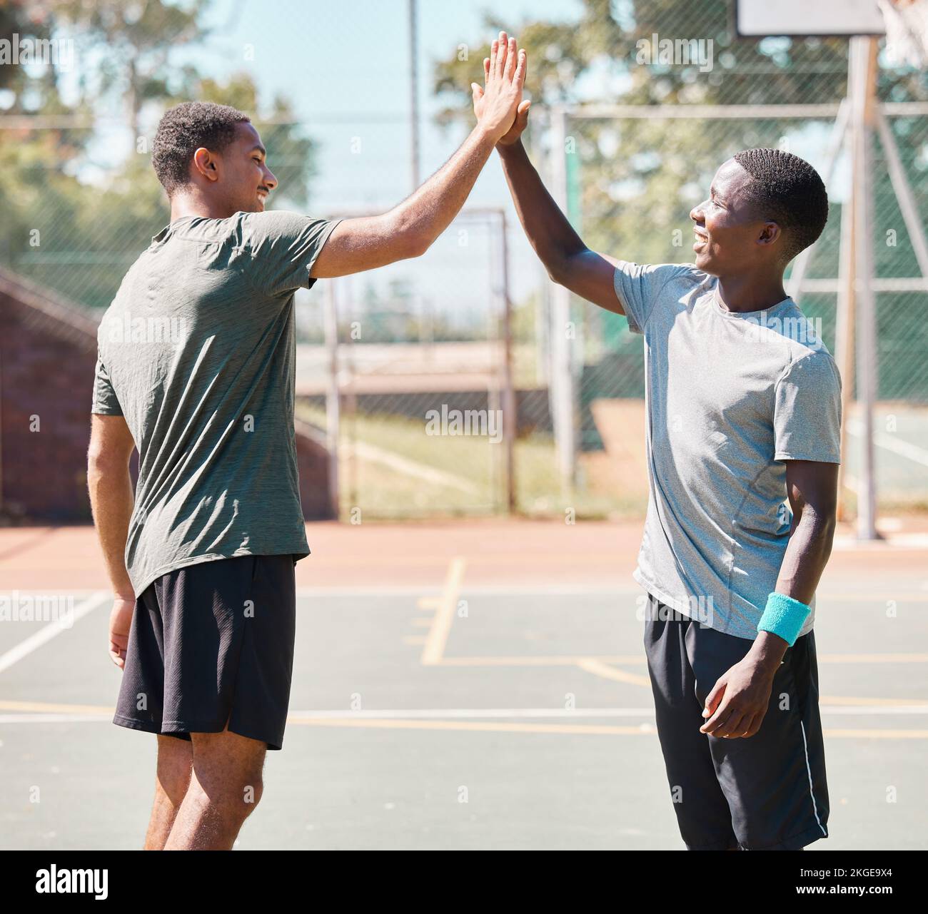 Fitness, high five and men on a basketball court for a game, practice ...