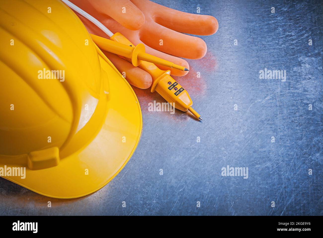 Insulating rubber gloves building helmet electrical tester on metallic ...