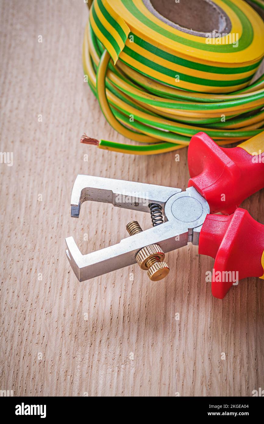 Insulation tape electrical cable wire stripper pliers on wooden board ...