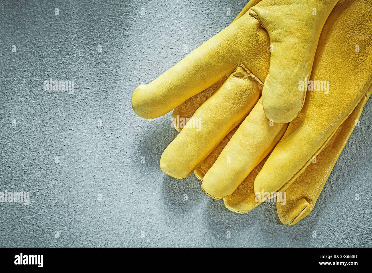 Leather protective gloves on concrete background construction concept ...