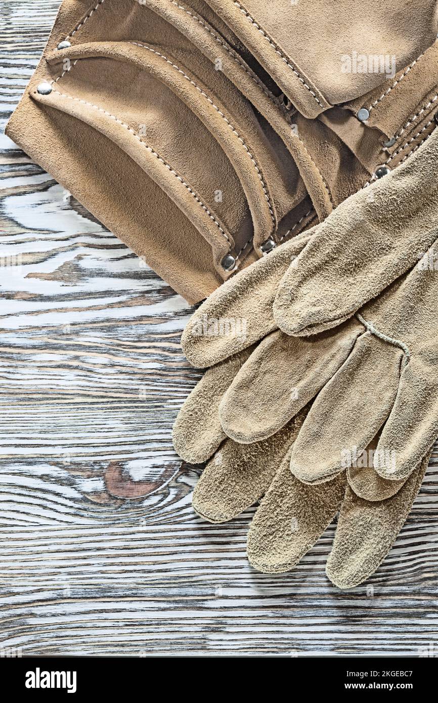 Leather safety gloves construction belt on wooden board Stock Photo - Alamy