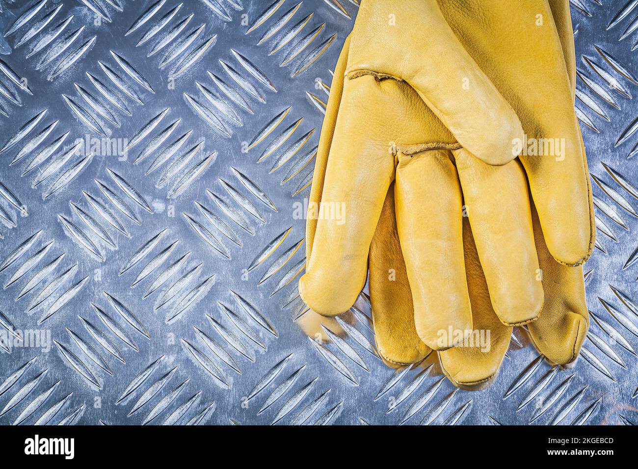 Leather protective gloves on corrugated metal plate construction ...