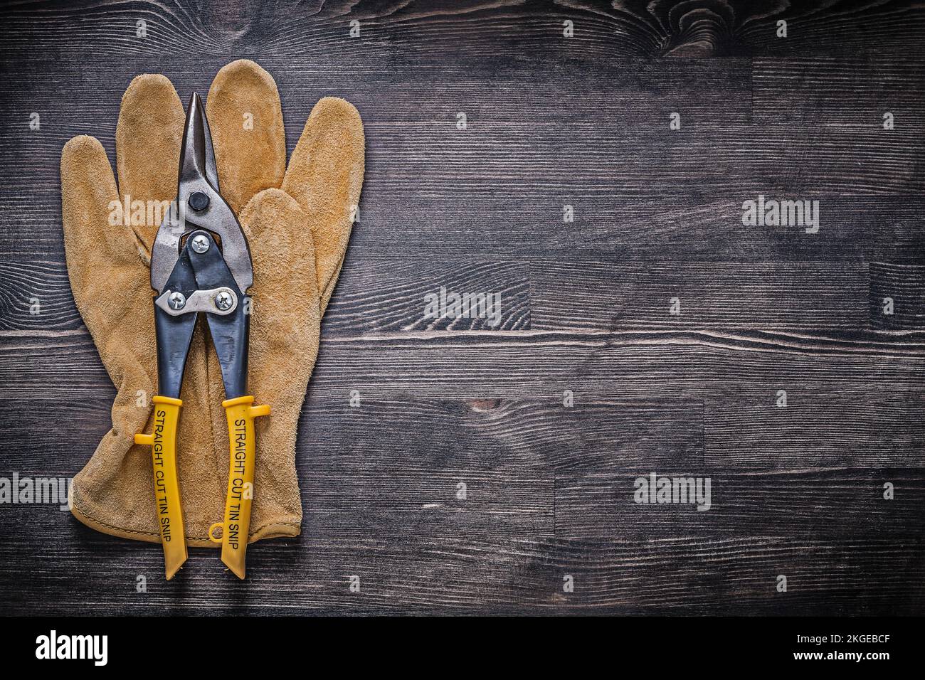 Leather safety glove tin snips on wood board construction concept Stock ...