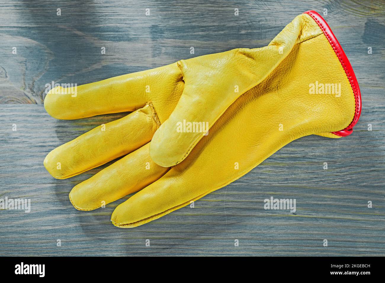 Leather safety glove on wooden board construction concept Stock Photo ...