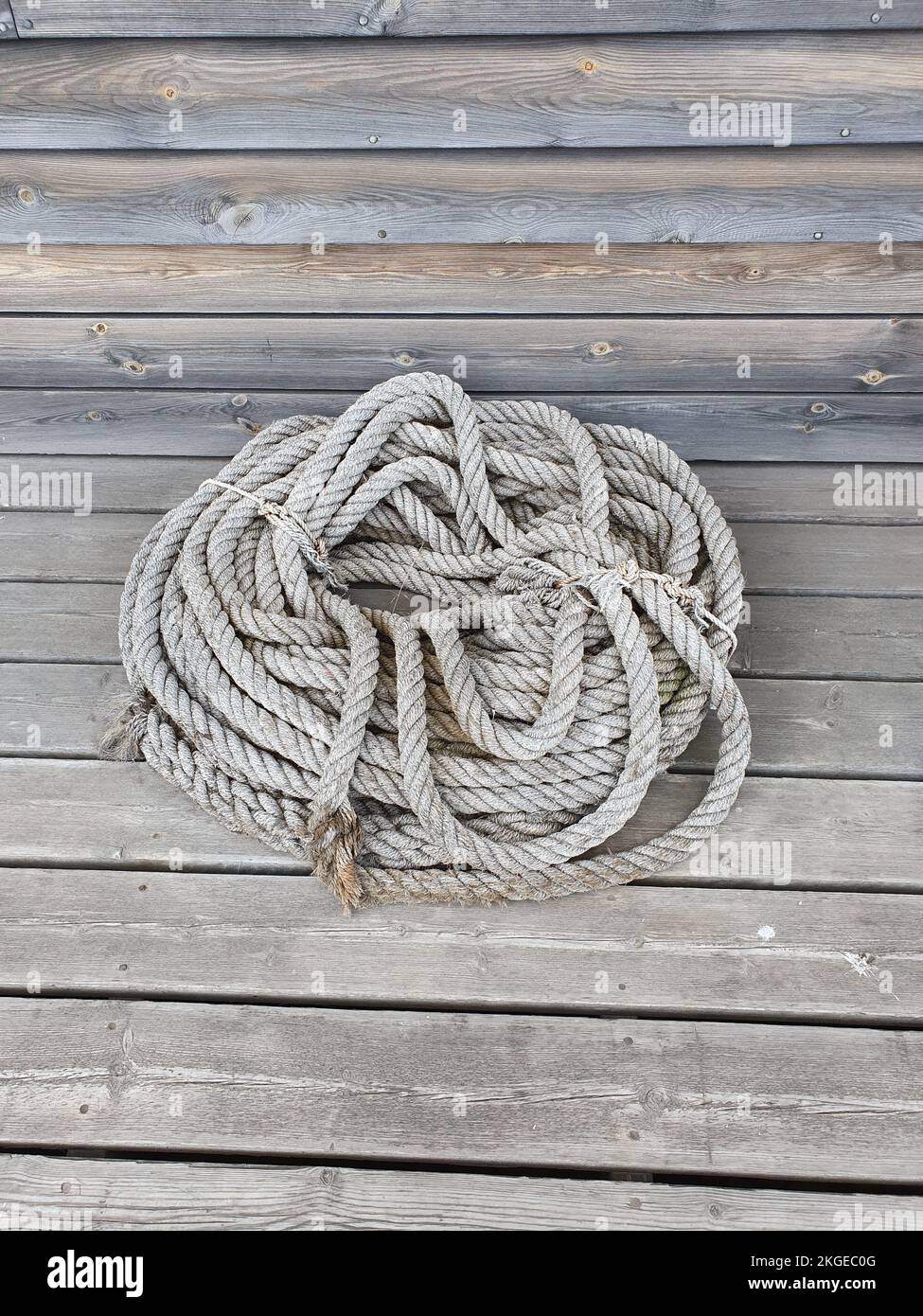 A vertical closeup of pile of nylon rope or line used to tie ships on ...