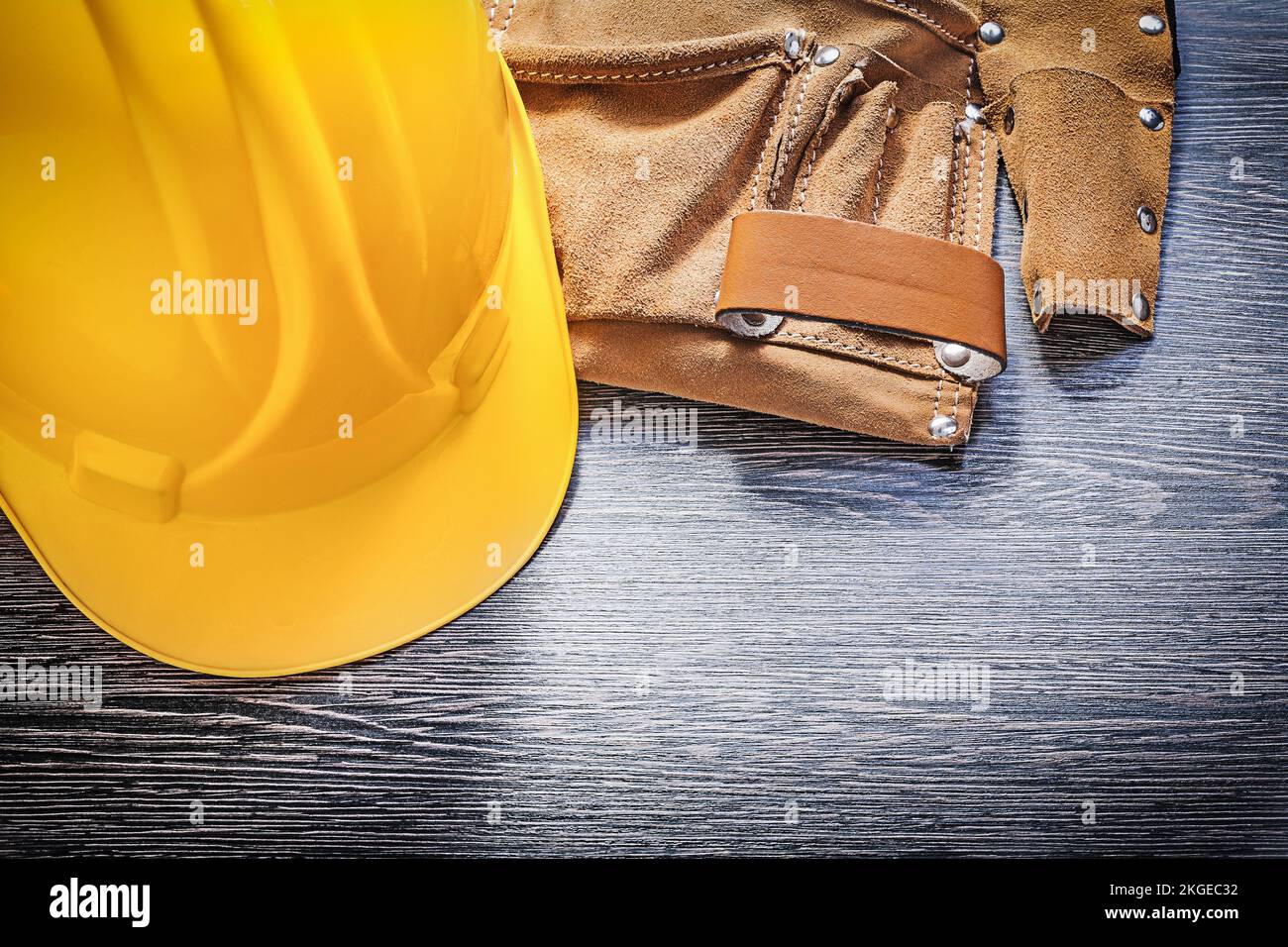 Leather tool belt safety building helmet on wood board construction ...