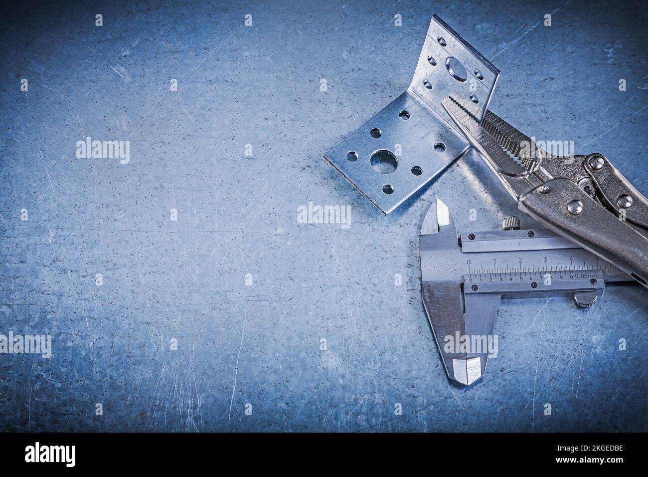 Lock jaw pliers vernier caliper angle bracket on metallic background ...