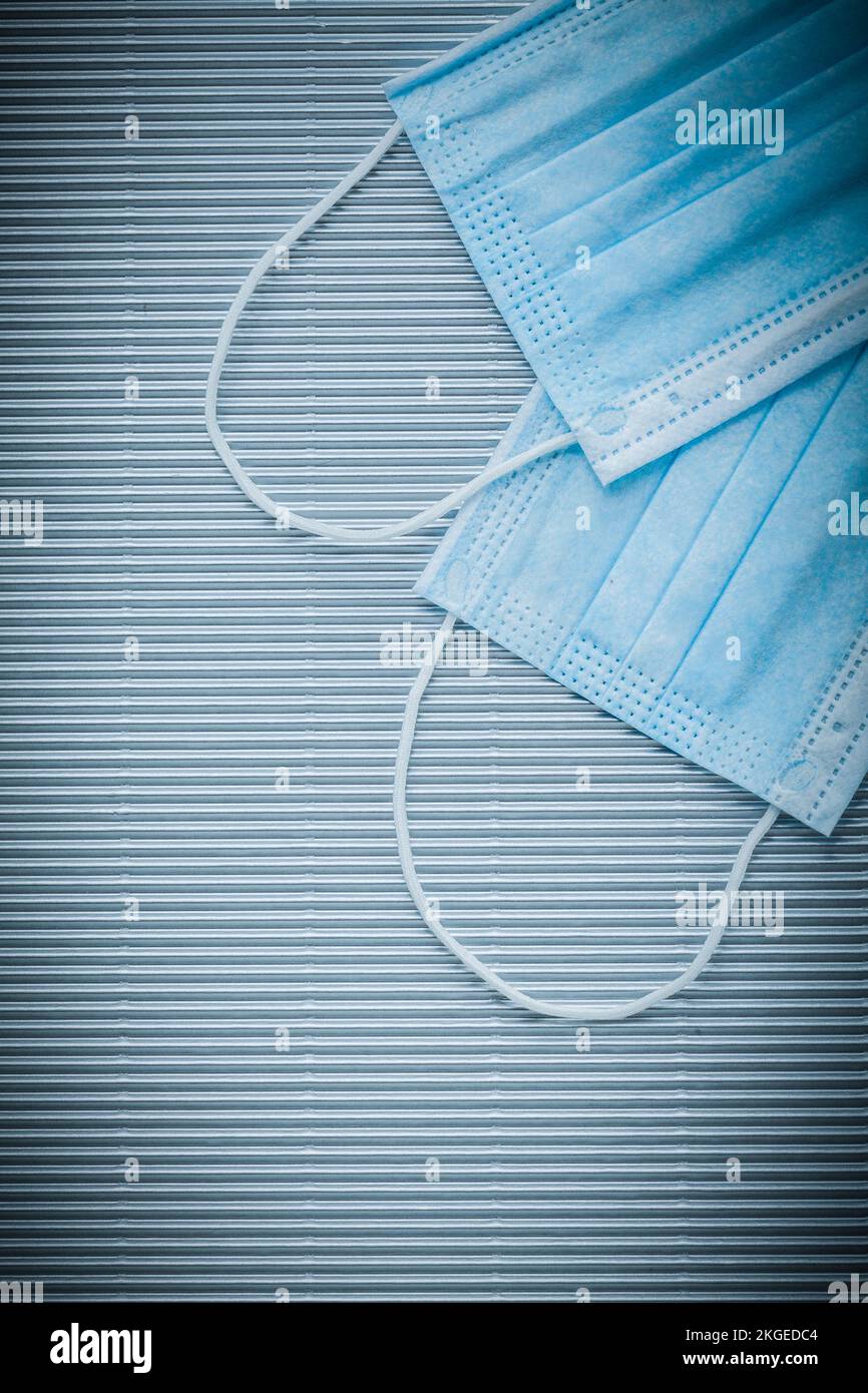 Medical disposable respiratory masks on striped background Stock Photo ...