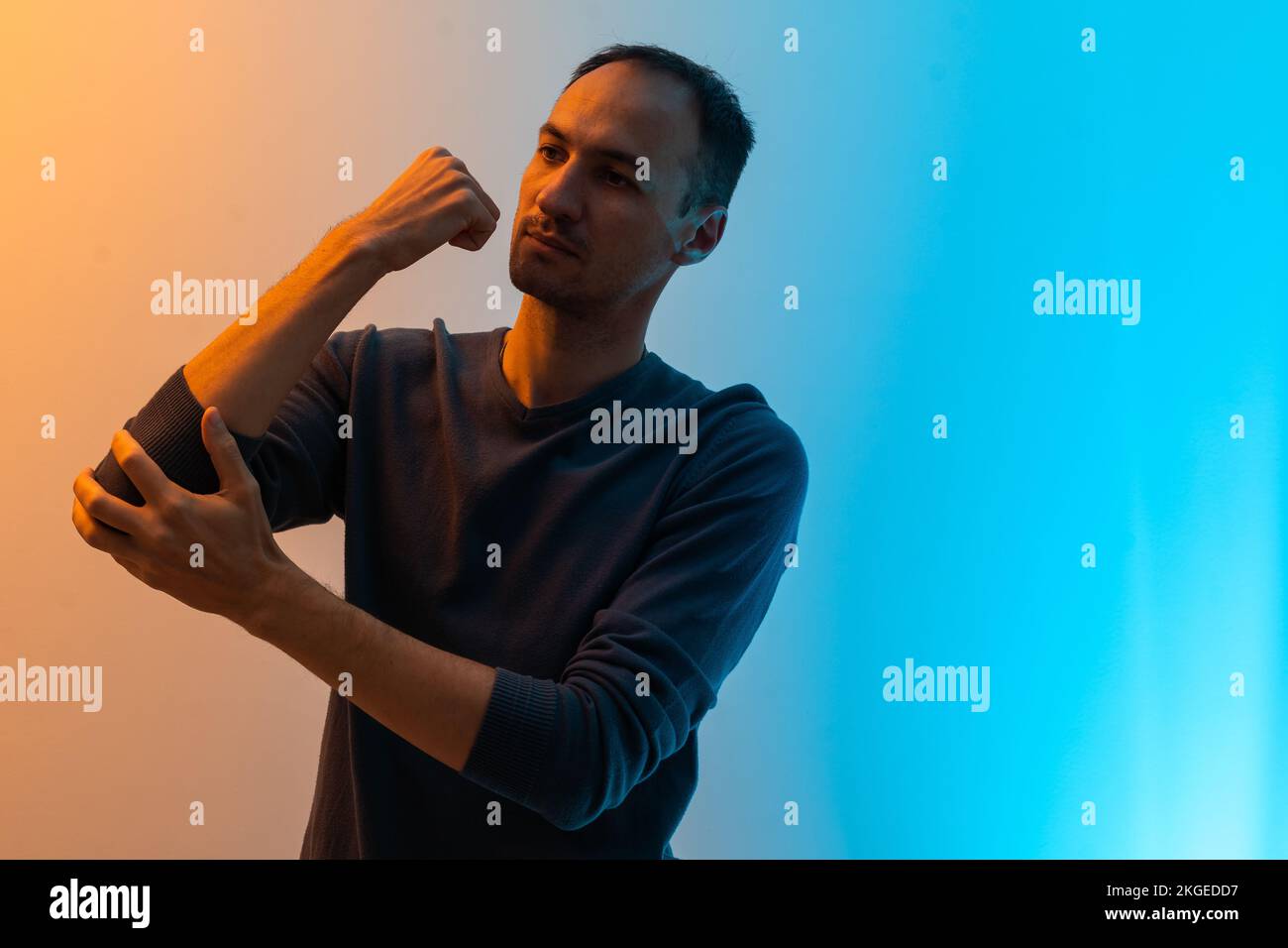 the man's arm hurts colored background Stock Photo - Alamy