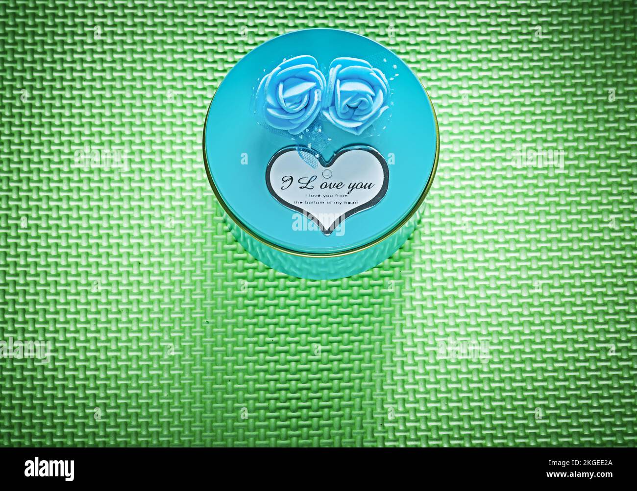 Metal blue round present box on green background holidays concept Stock ...