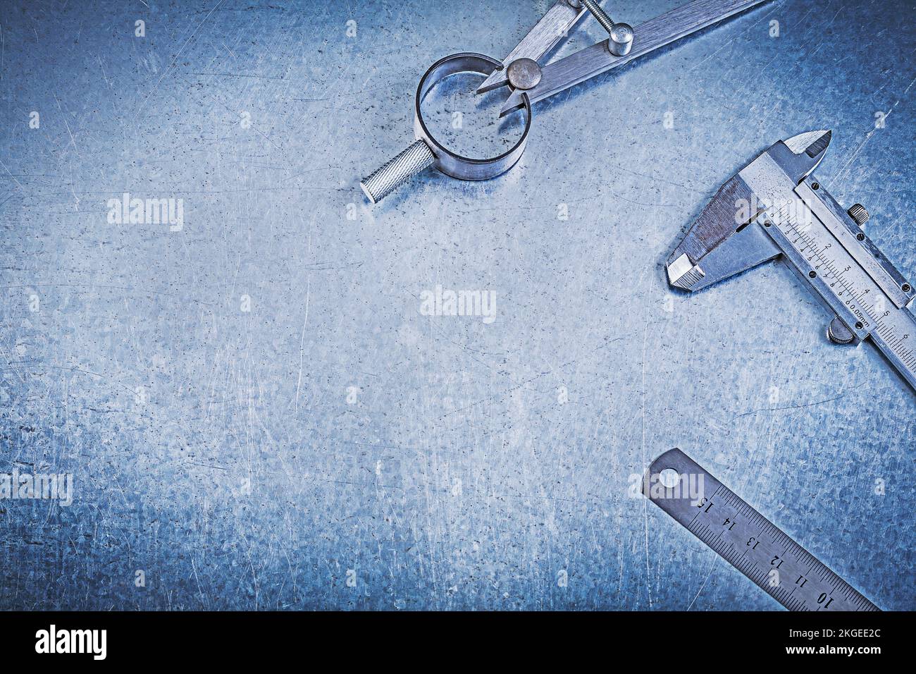 Metal construction divider ruler vernier caliper on metallic background ...