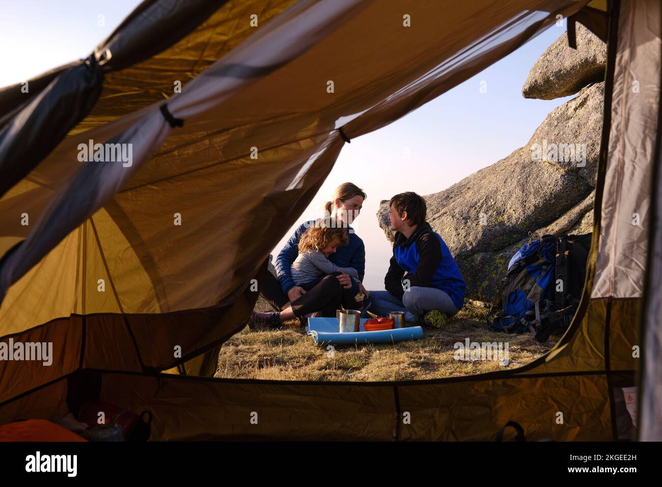 Family enjoying their camping trip in the mountains Stock Photo - Alamy