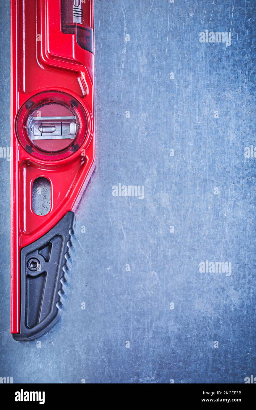 Metal construction level on scratched metallic background maintenance ...