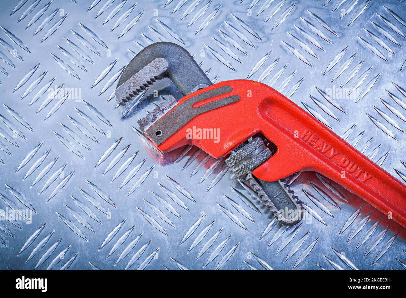 Metal pipe wrench on fluted metallic sheet construction concept Stock ...