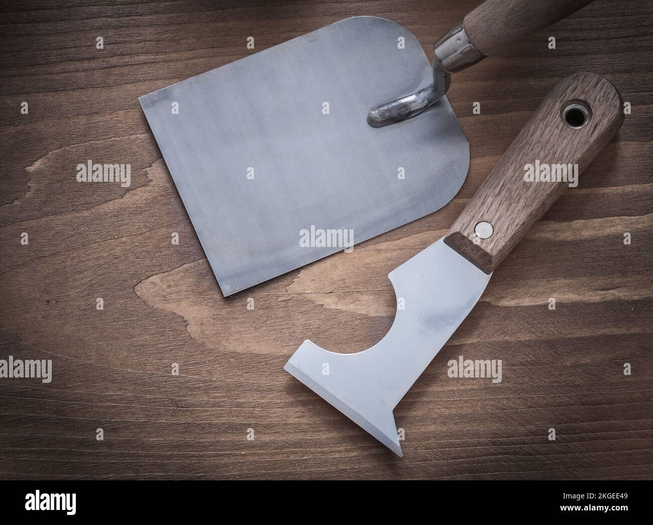 Metal putty knife bricklaying trowel on wooden surface construction ...