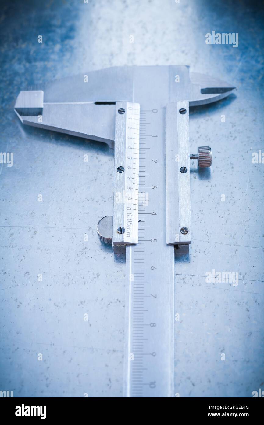 Metal slide caliper on metallic background vertical view construction ...
