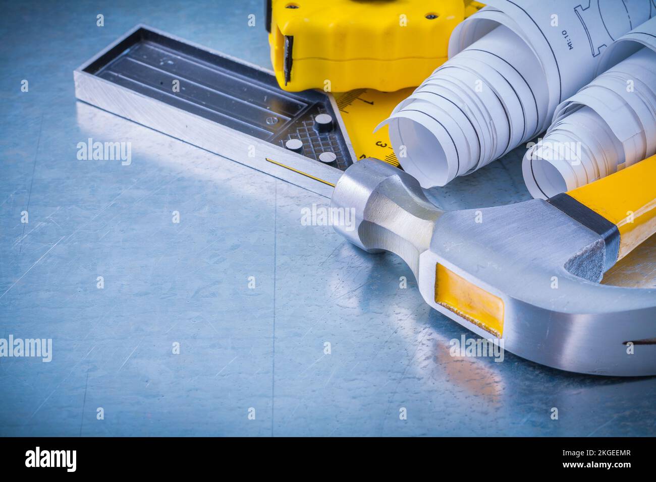 Metallic background with construction plans claw hammer square ruler ...
