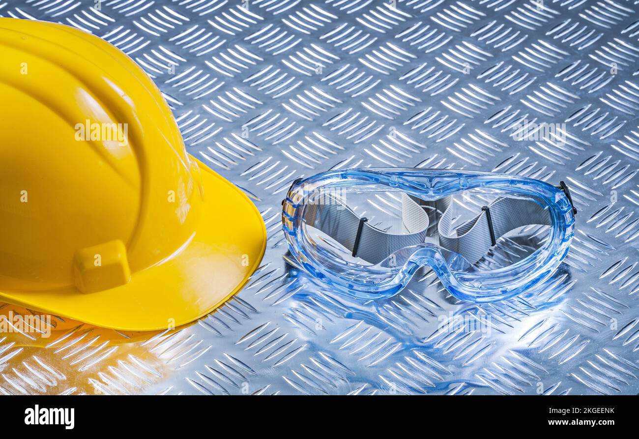 Multiple-purpose goggles building helmet on corrugated metal background ...