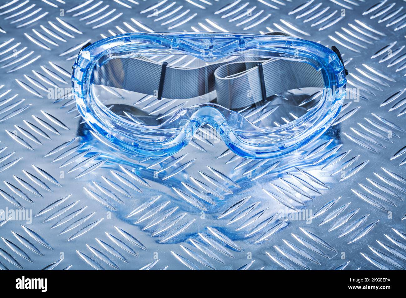 Multiple-purpose goggles on grooved metal background construction ...