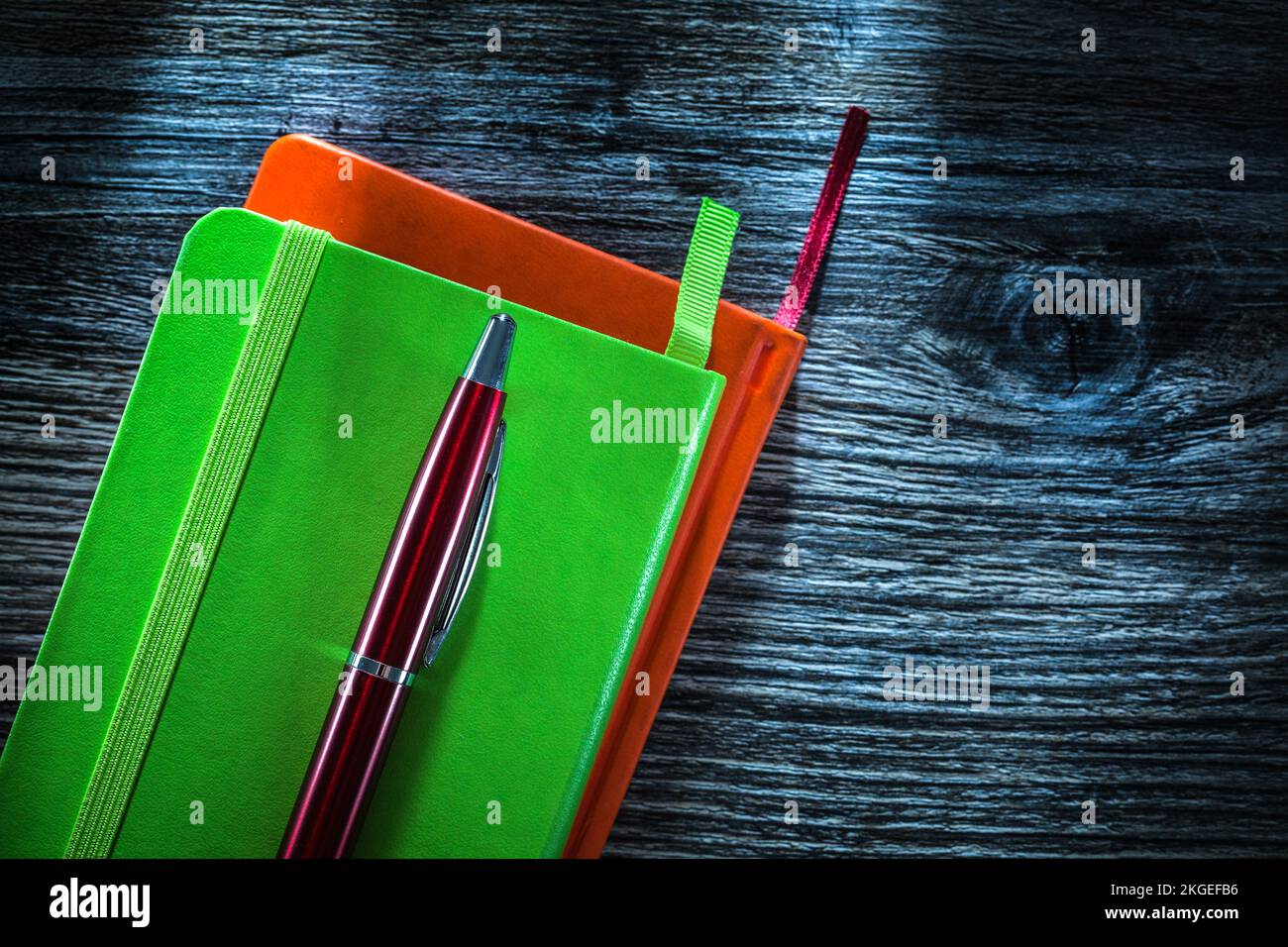 New office notebooks pen on wooden board Stock Photo - Alamy
