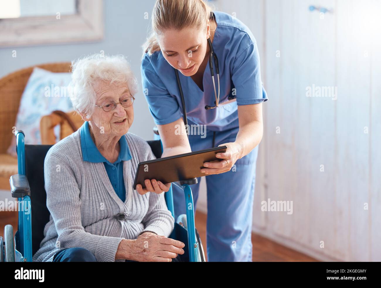 Nursing home, woman or doctor with tablet checking medical results ...