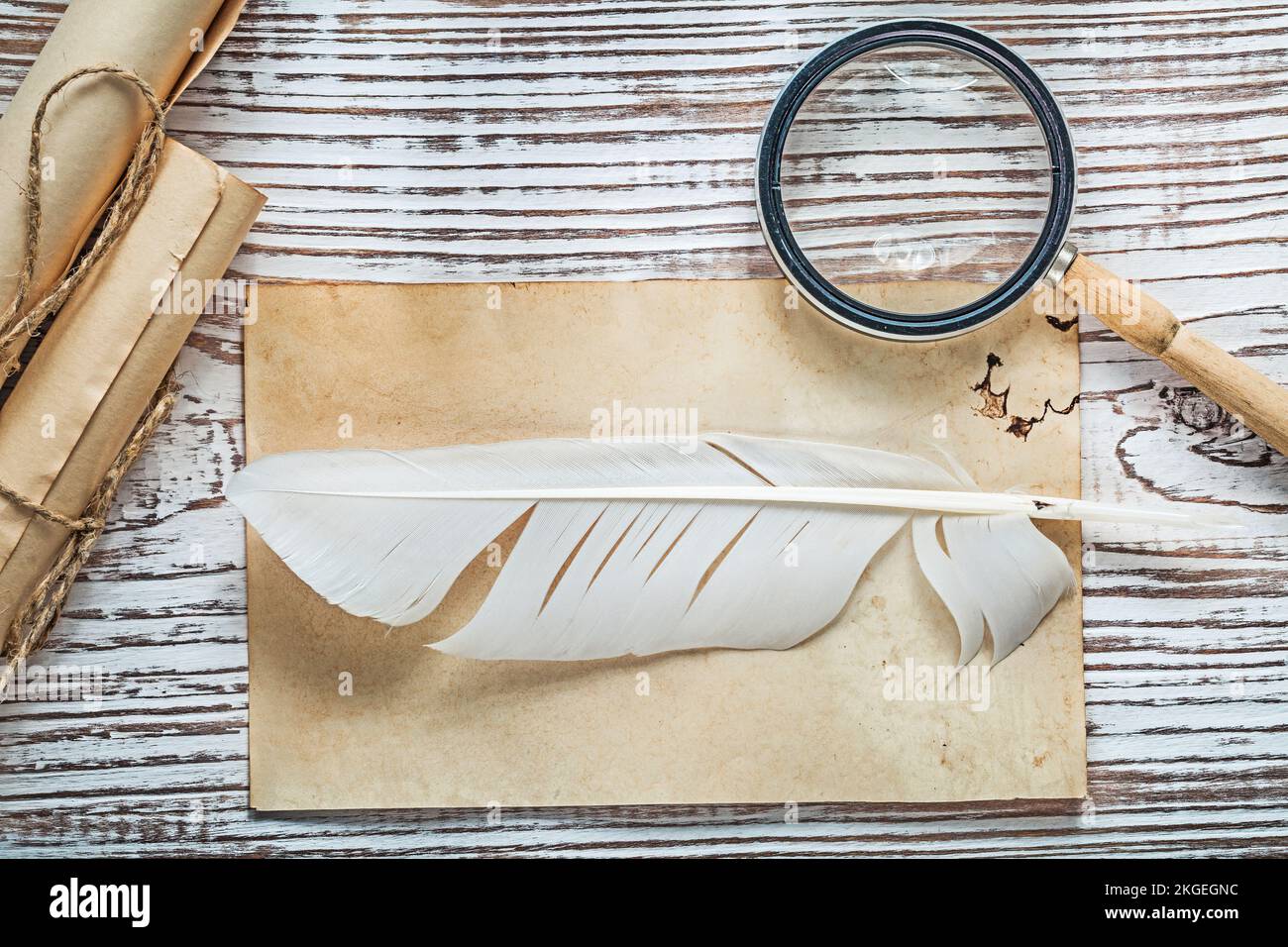 Old sheet corded paper roll feather magnifying glass on vintage wooden ...