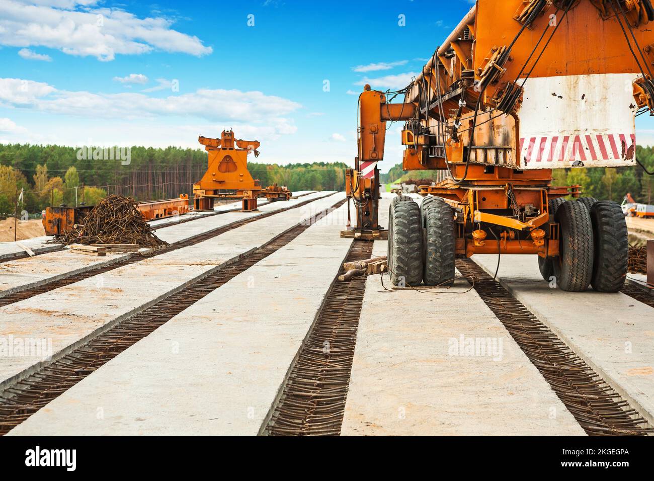 old roadworking mashines on bridge under construction Stock Photo - Alamy