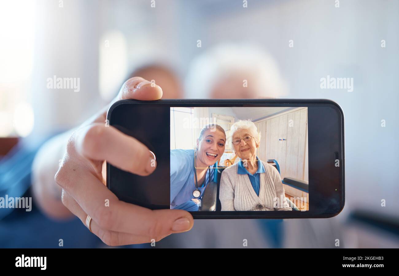 Phone, nurse and happy old woman take a selfie on screen after ...