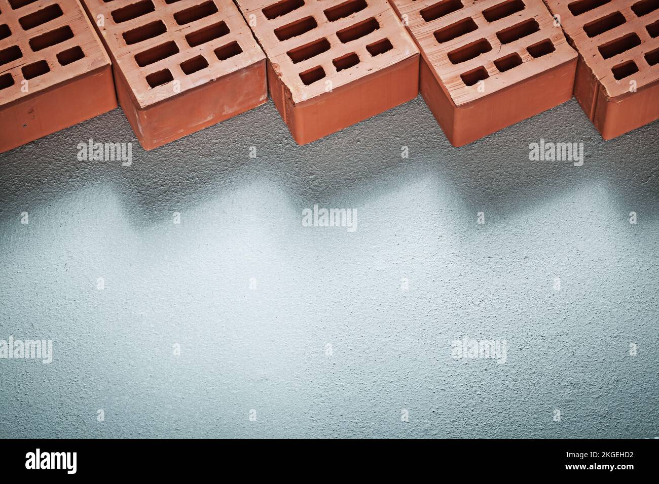 Orange bricks on concrete surface construction concept Stock Photo - Alamy