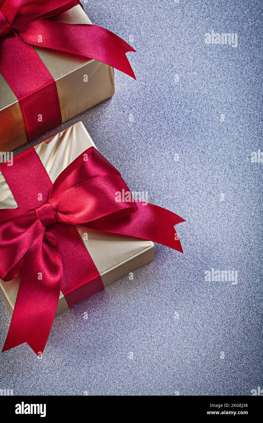 Packed in glittery paper gift boxes on grey background holidays concept ...