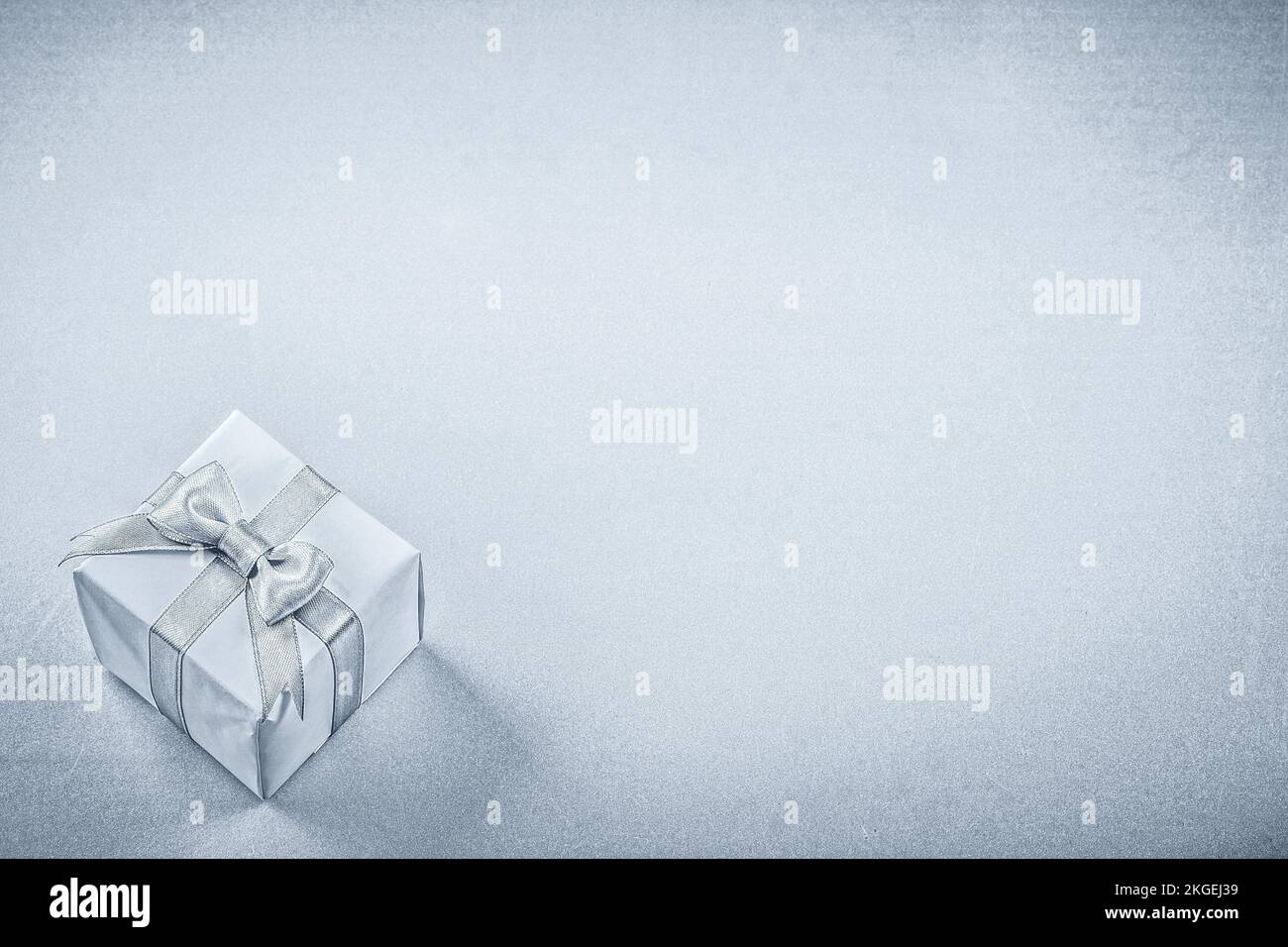 Packed present box with tied bow on blue background Stock Photo - Alamy