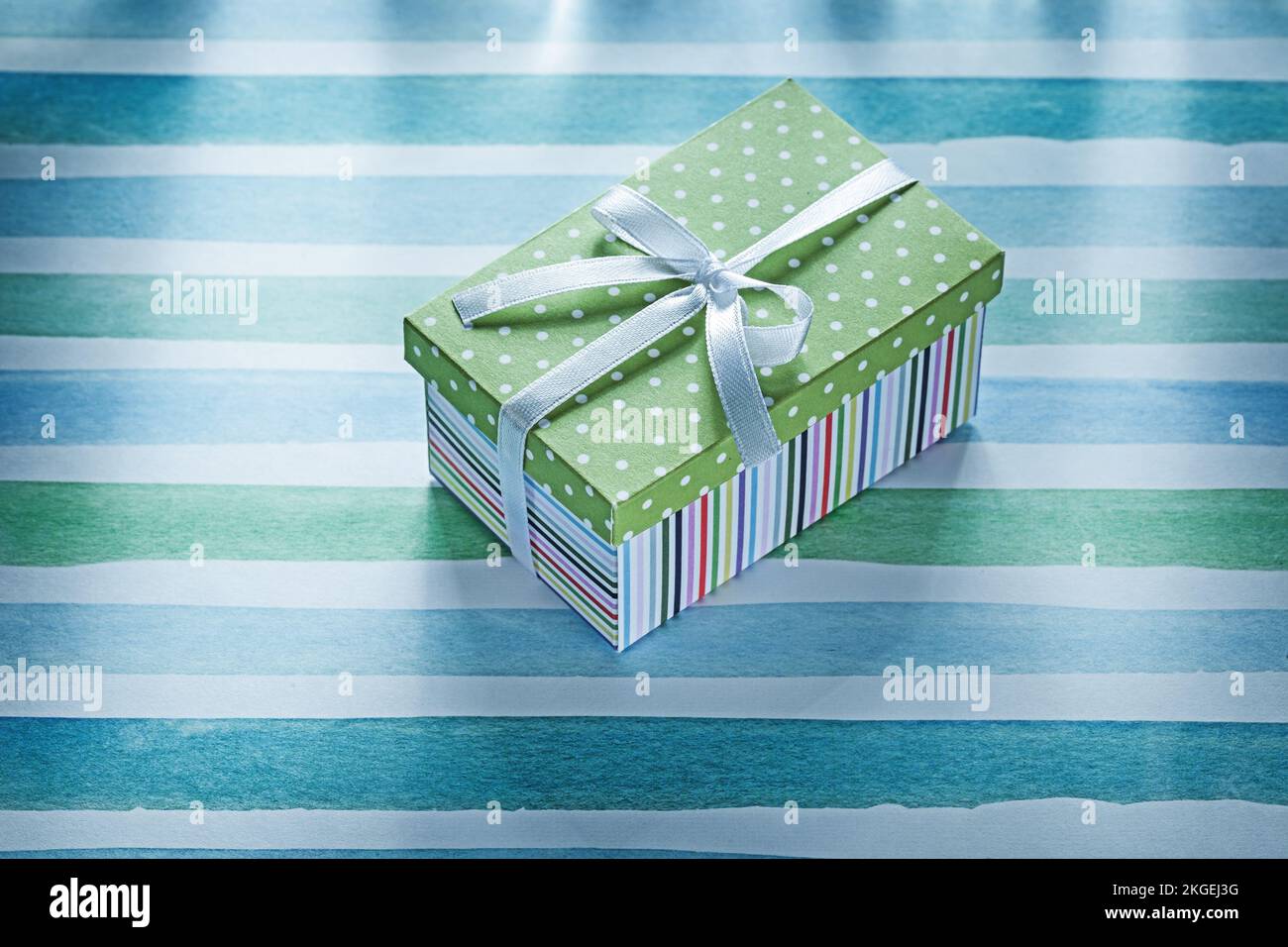 Packed present box on blue striped fabric holidays concept Stock Photo ...