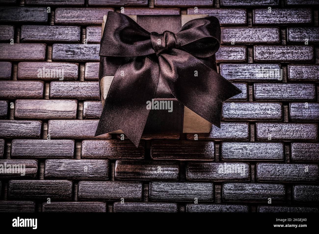 Packed present box with brown ribbon on wicker wooden mat Stock Photo ...