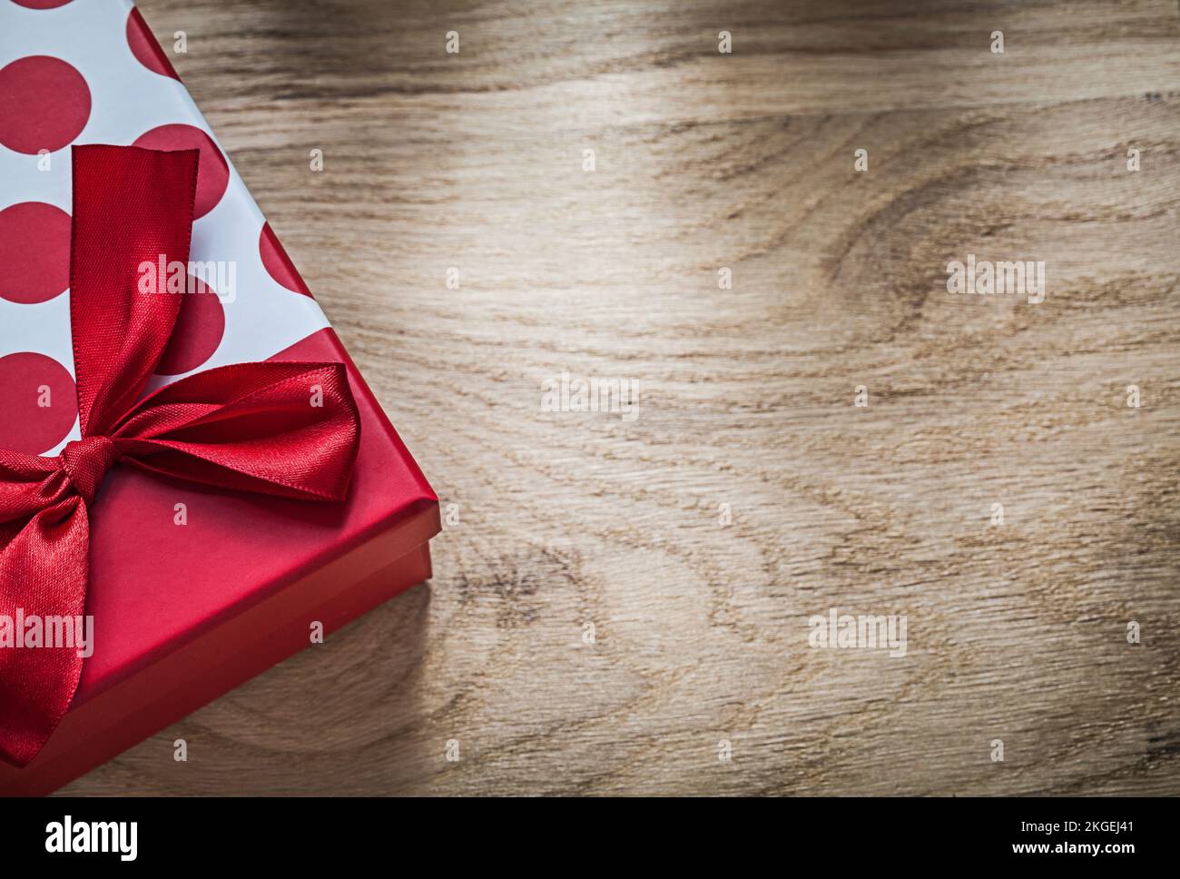 Packed present box with red knot on wooden board holidays concept Stock ...