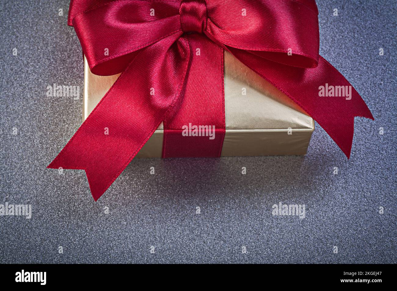 Packed present box with red ribbon on grey background holidays concept ...