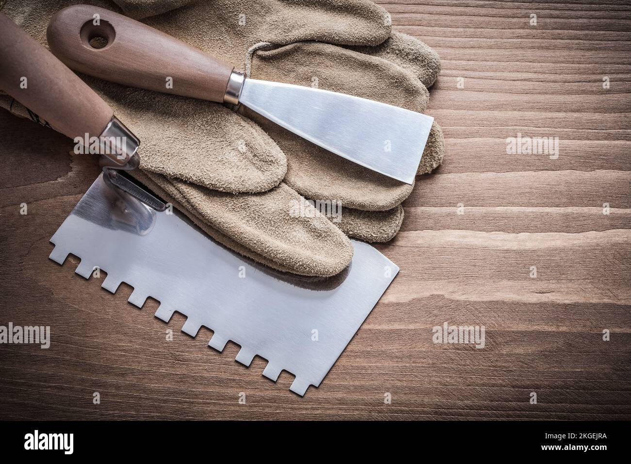 paint scraper and putty knife with working glove Stock Photo - Alamy