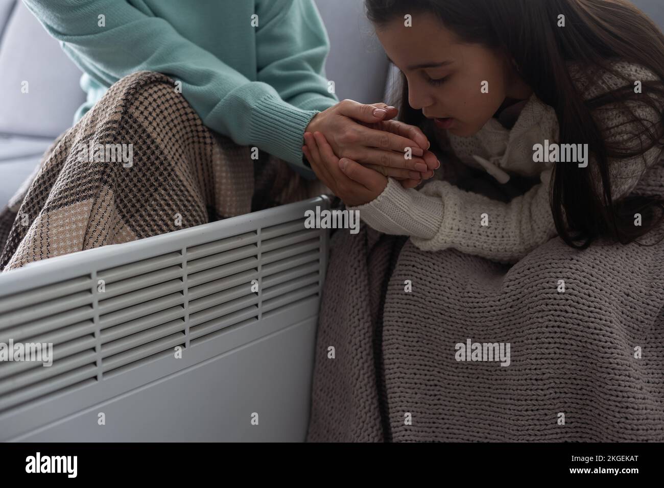 Child warming hands near electric heater at home, closeup Stock Photo ...