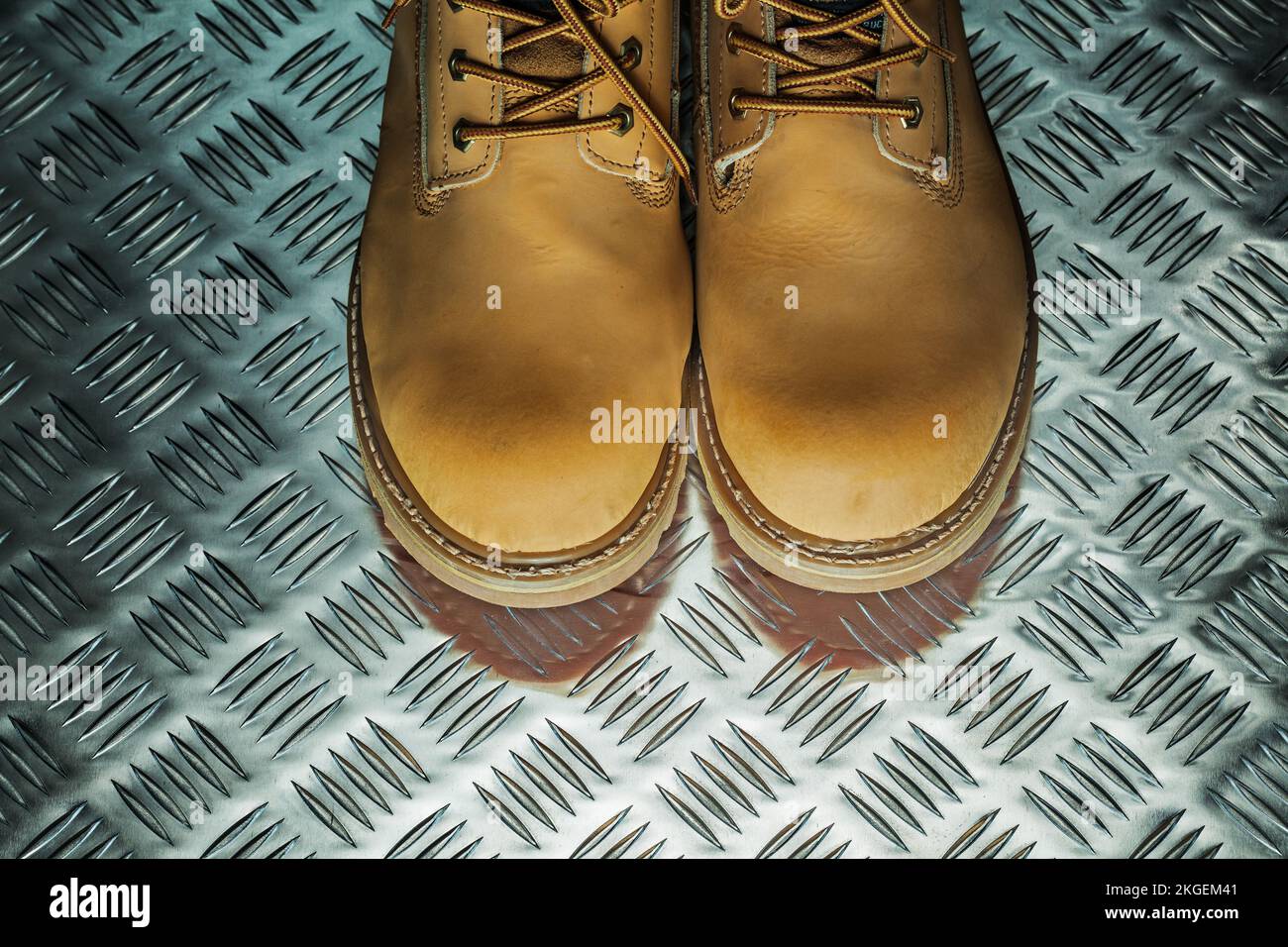 Pair of safety boots on corrugated metal plate Stock Photo - Alamy