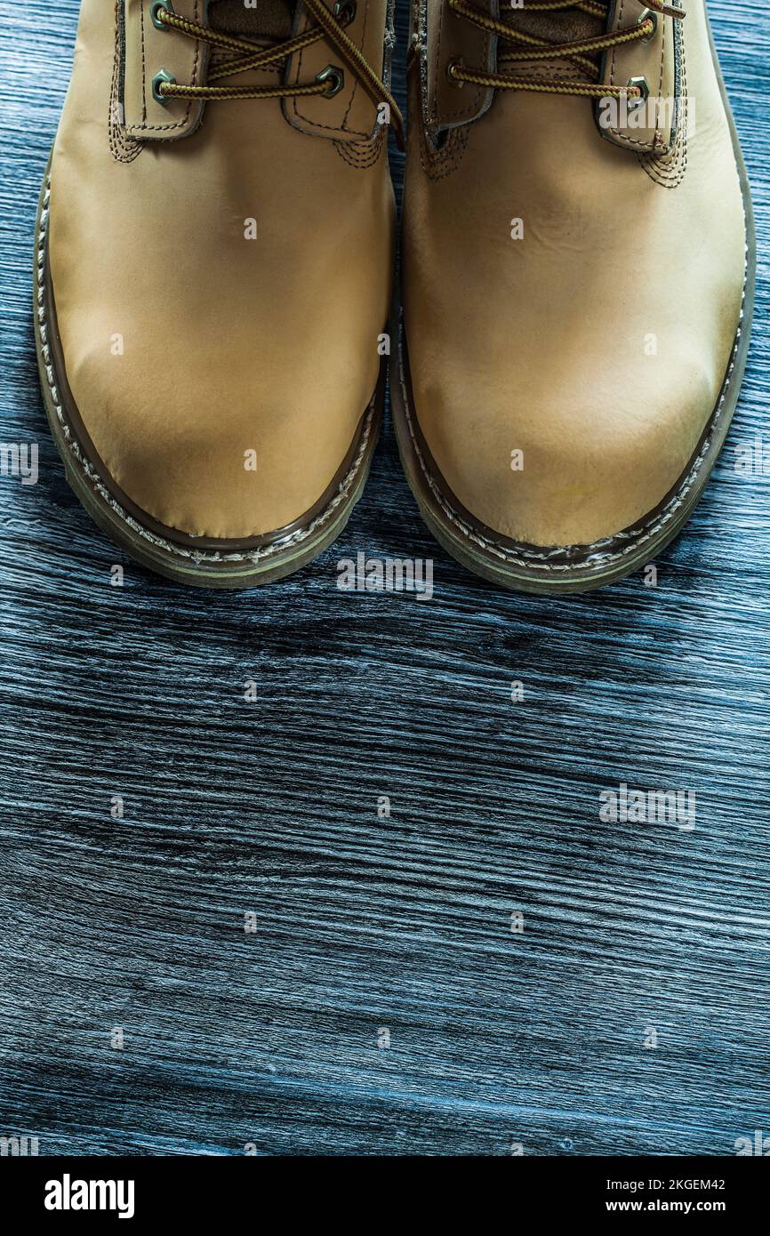 Pair of safety boots on wooden board Stock Photo - Alamy