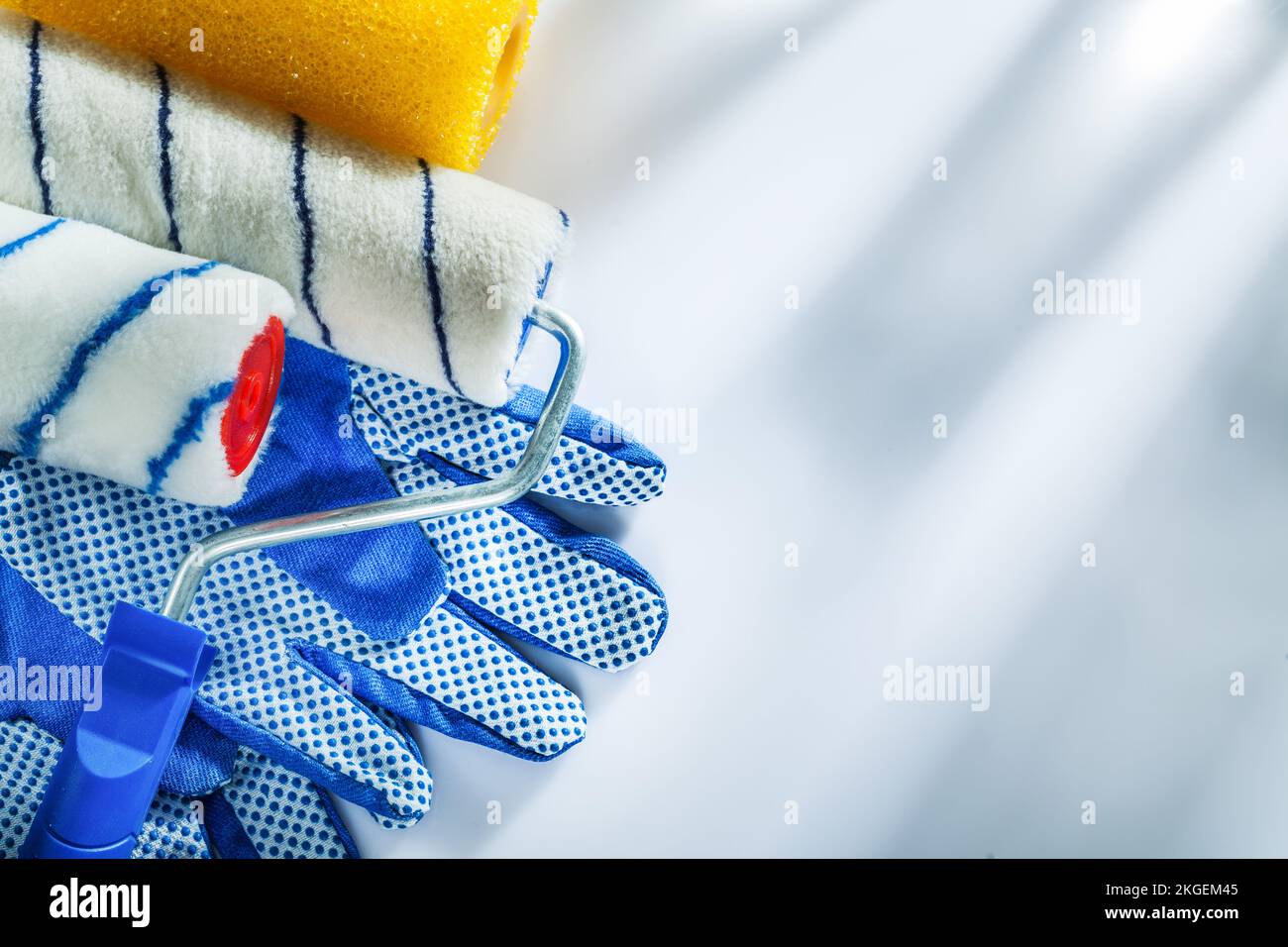 Pair of protective gloves paint rollers on white background Stock Photo ...