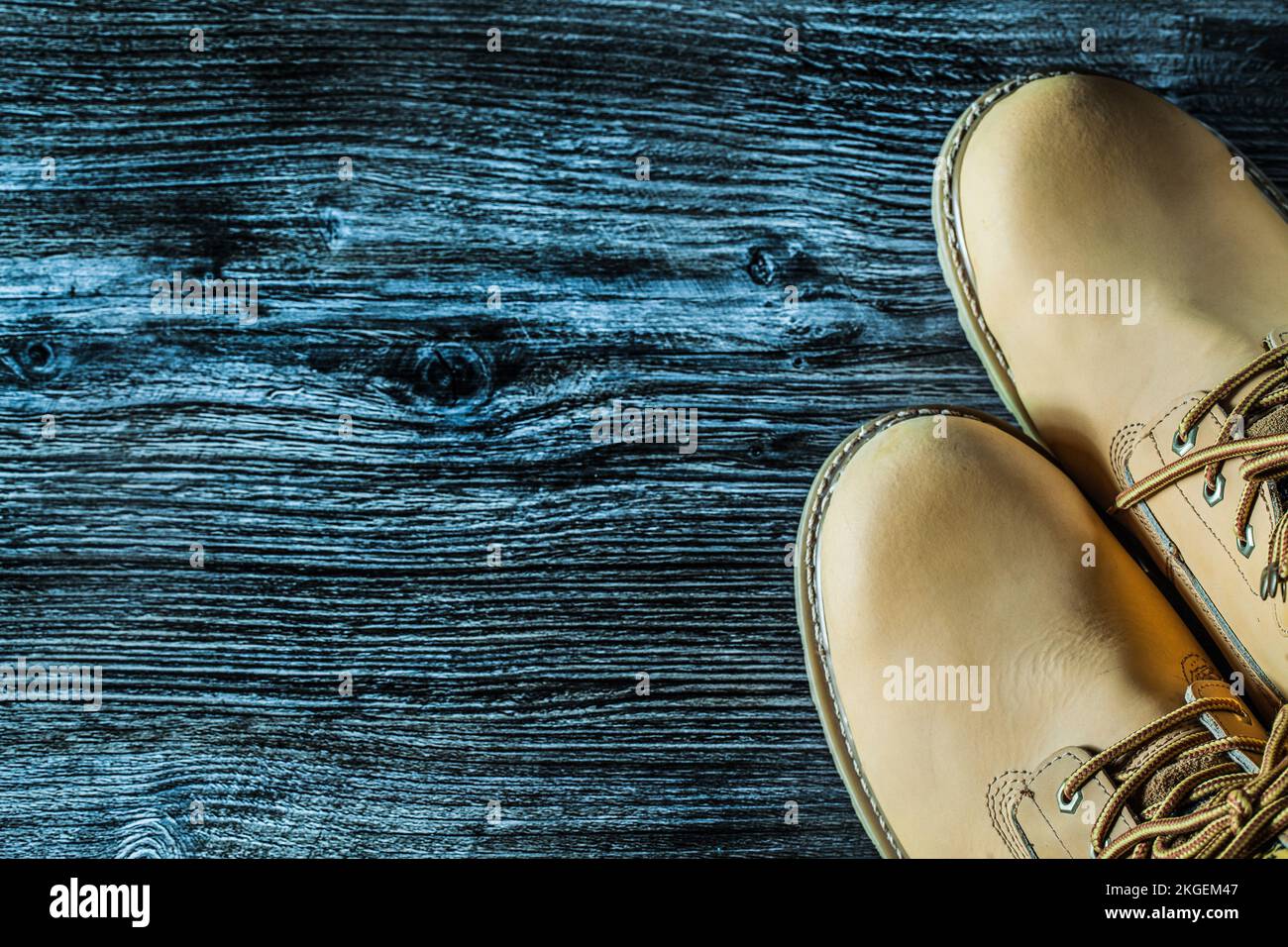 Pair of safety boots on vintage wooden board Stock Photo - Alamy