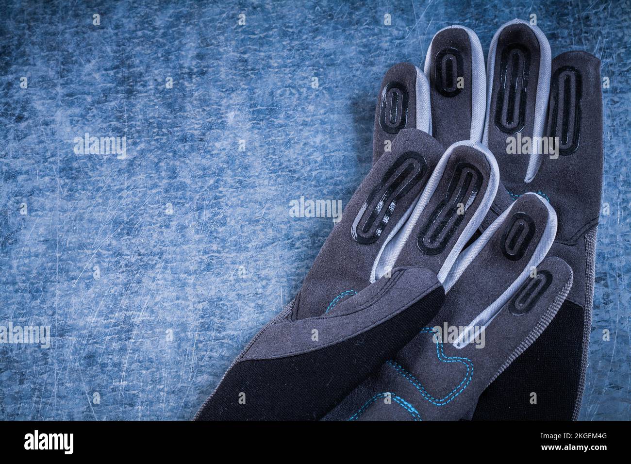 Pair of staff gardening gloves on scratched metallic background Stock ...