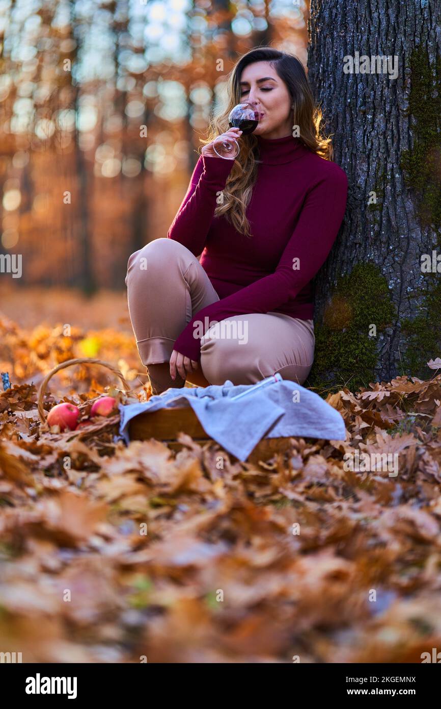 Beautiful plus size young indian woman enjoying a glass of red wine in ...