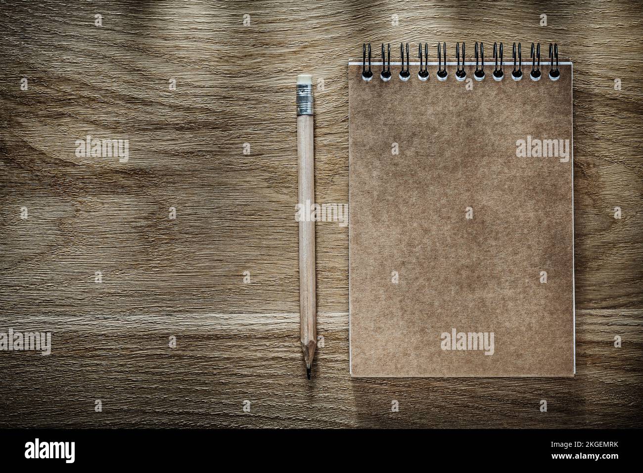Pencil brown notebook on wooden board Stock Photo - Alamy