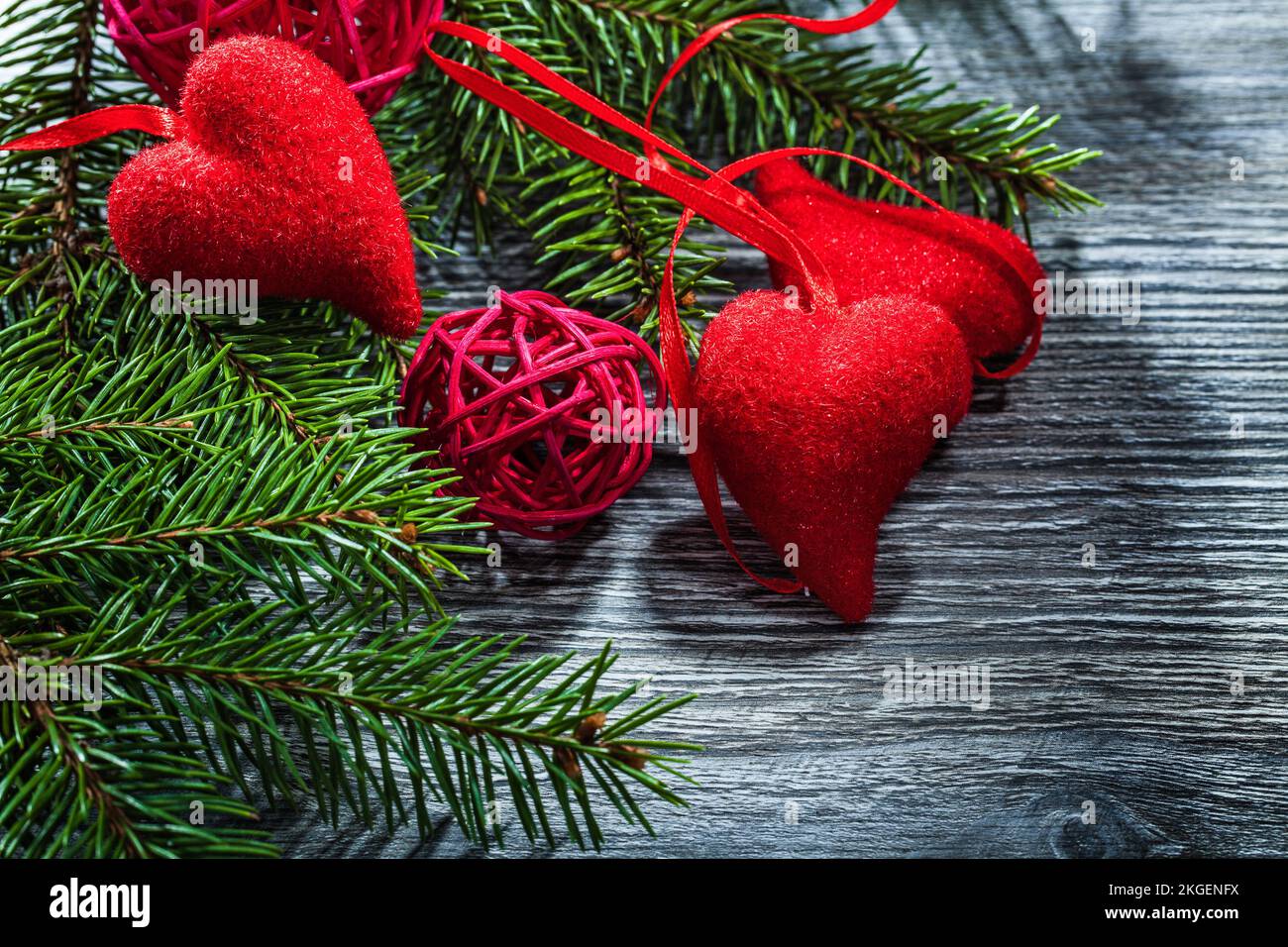 Pine tree branches red hearts balls on wooden board Stock Photo - Alamy