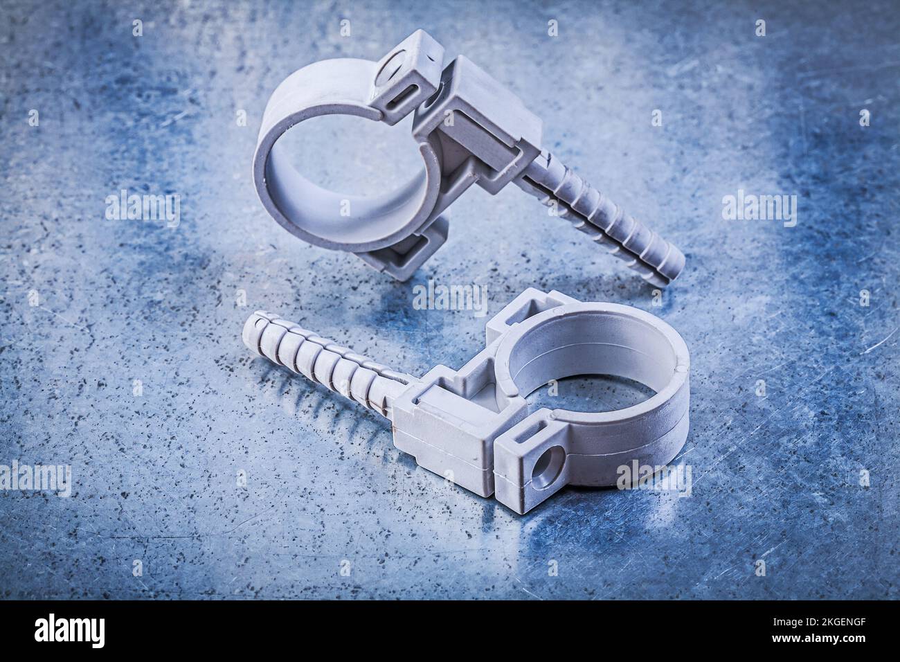 Pipe clamps on metallic background construction concept Stock Photo - Alamy