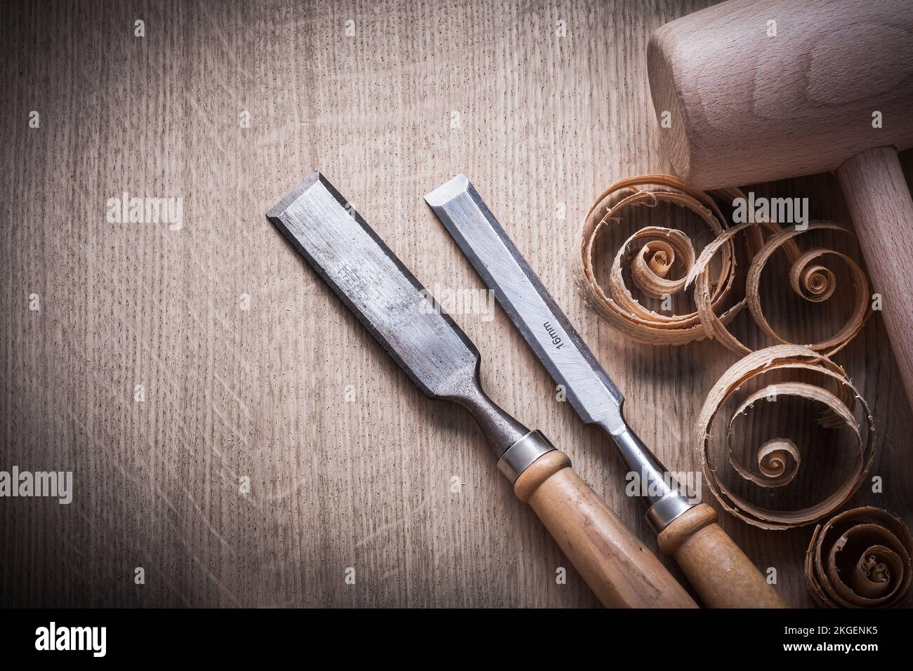 Planing chips wooden mallet carpenter’s flat chisels on wood surface ...