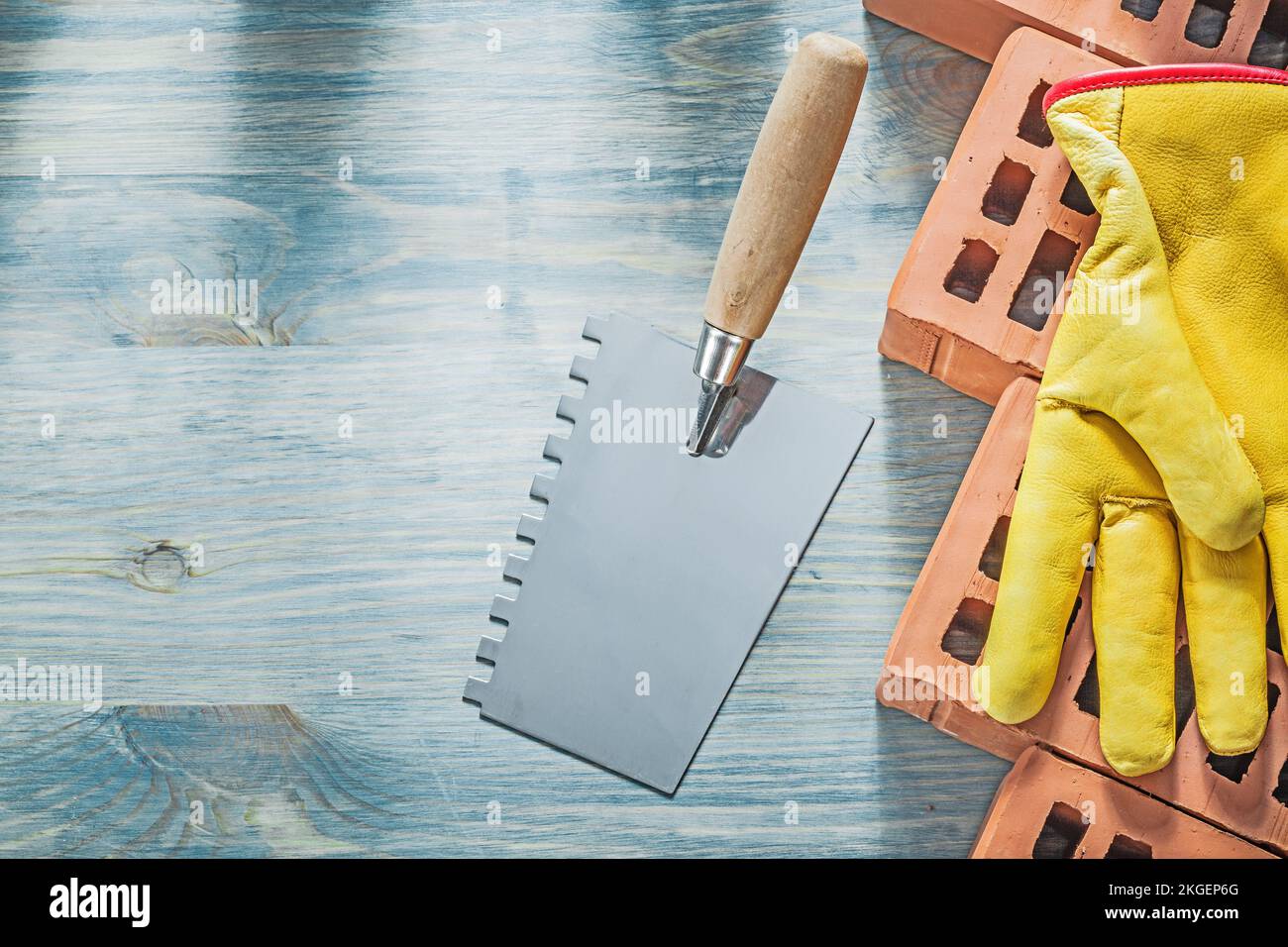 Plastering trowel red bricks safety gloves on wood board bricklaying ...