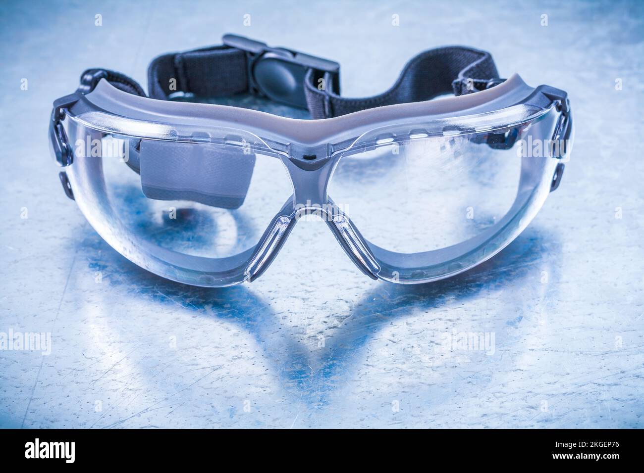 Plastic transparent safety glasses on metallic background construction ...